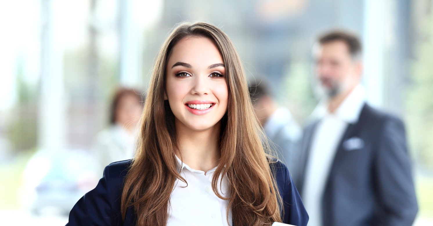 Business woman standing with a tablet in her hands - SOFTFIN® online for success